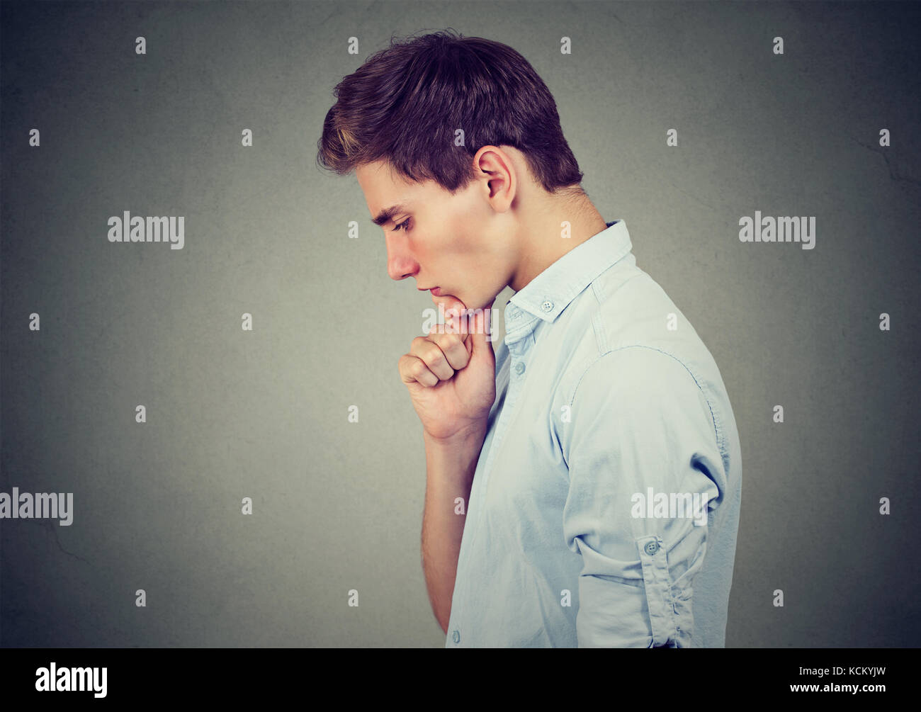Sorrowful young man thoughtful looking down Stock Photo - Alamy