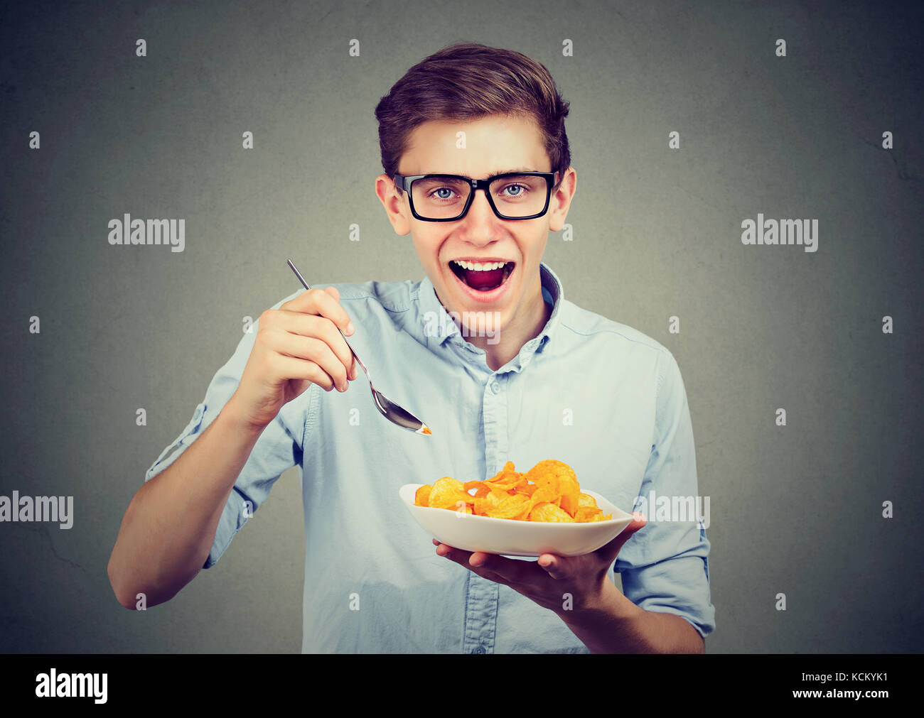 Fat person eating chips hi-res stock photography and images - Alamy