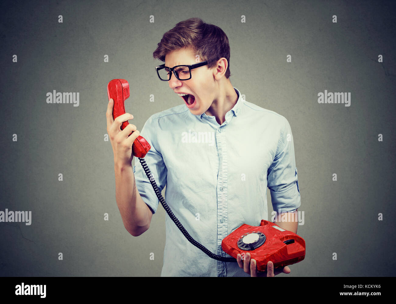 Young man screaming on the phone Stock Photo - Alamy