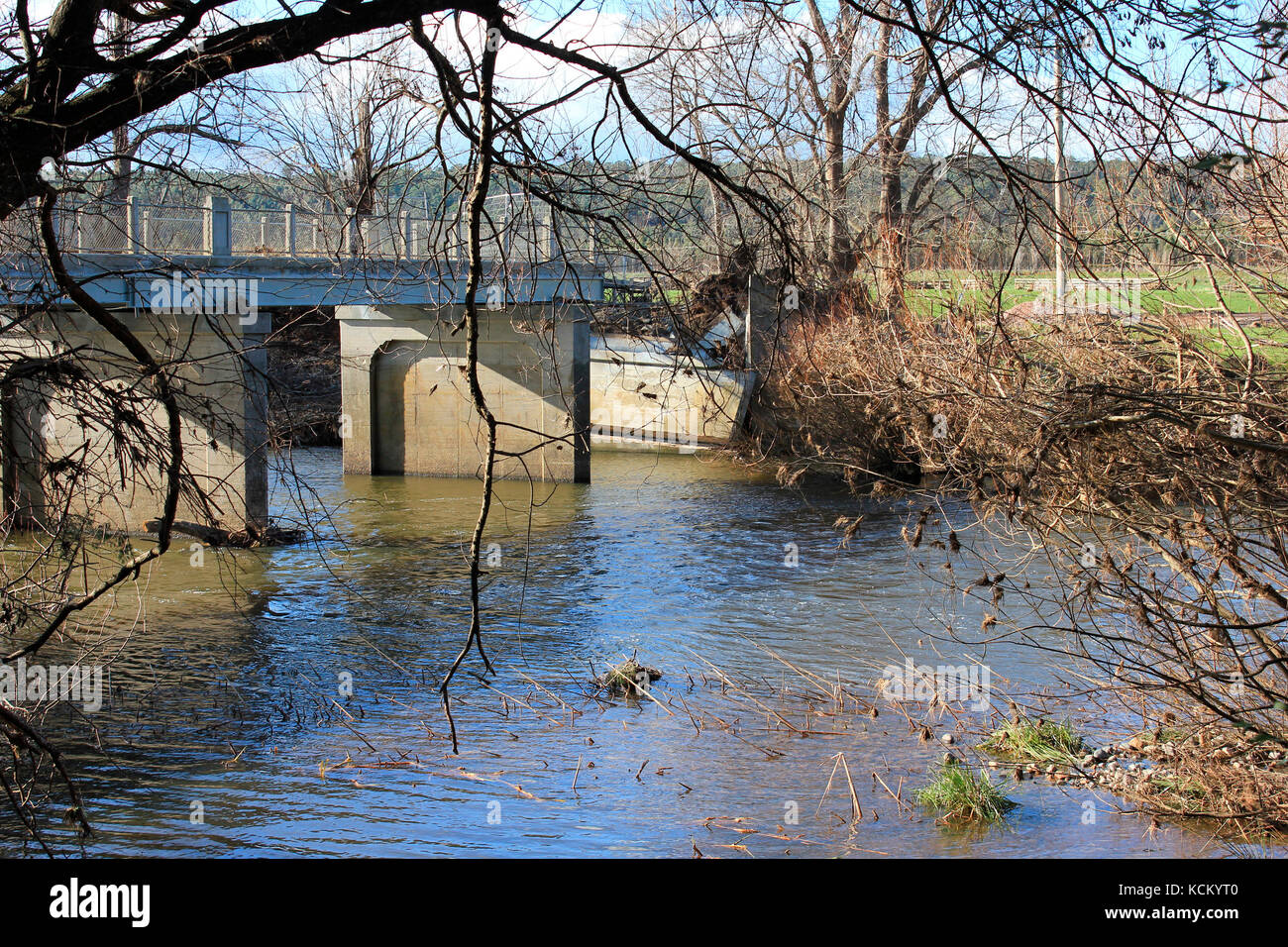 Concrete bridge damaged by severe flood. Its far section was carried up ...