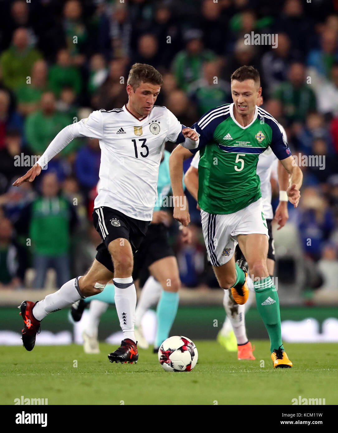 Germany's Thomas Muller (left) and Northern Ireland's Jonny Evans ...