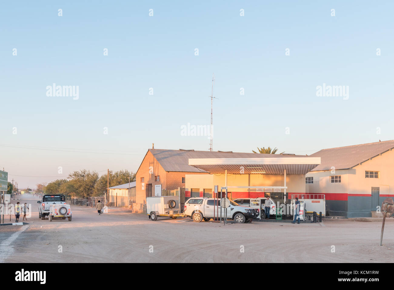 AROAB - JULY 5, 2017: A sunset street scene, with a gas station and ...