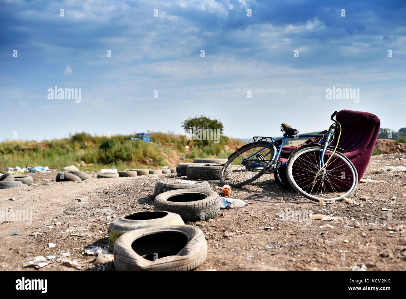 Old retro bike left discarded at a landfill site with bags of human and ...