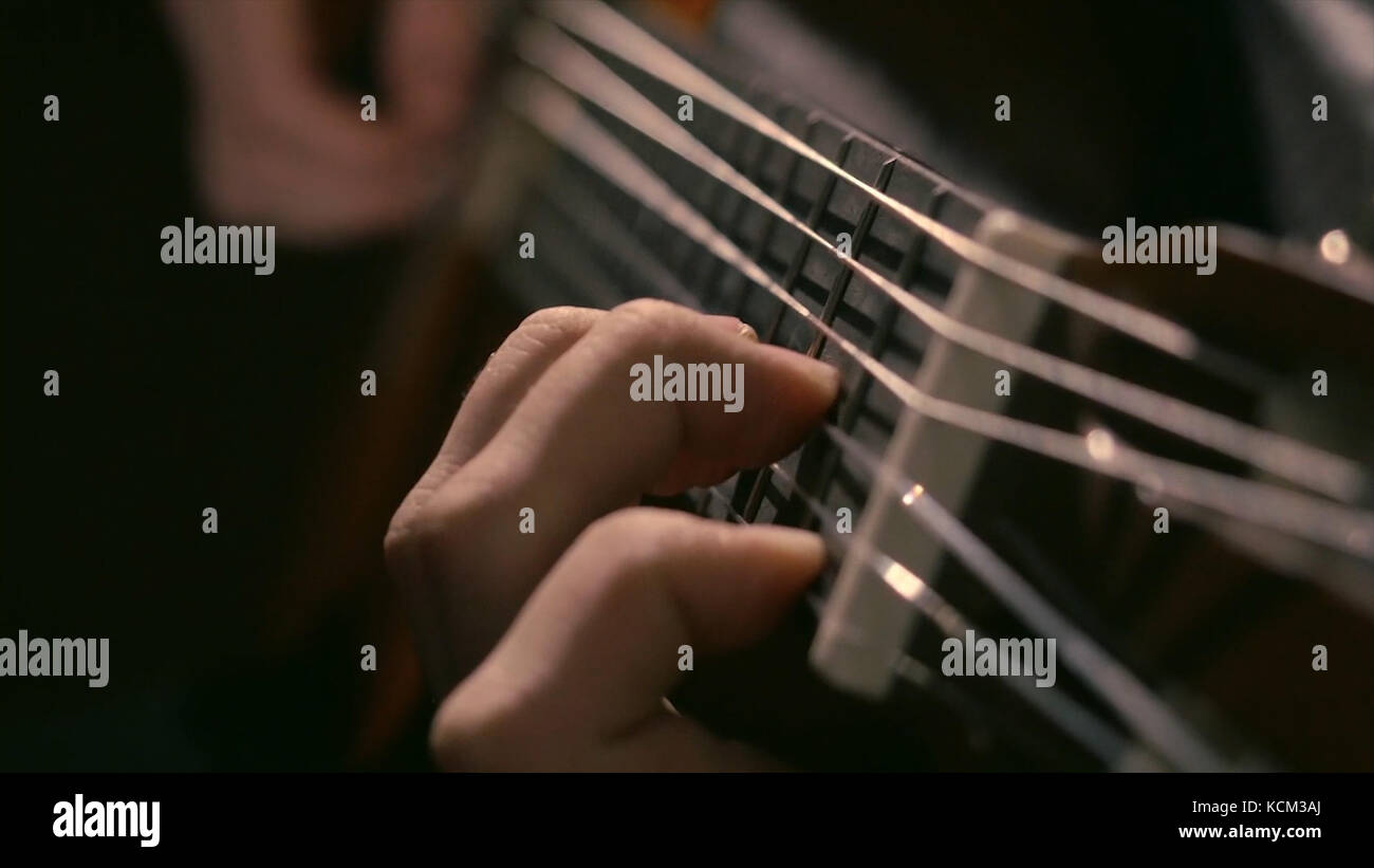 Practicing in playing guitar. Handsome young men playing guitar. Play ...