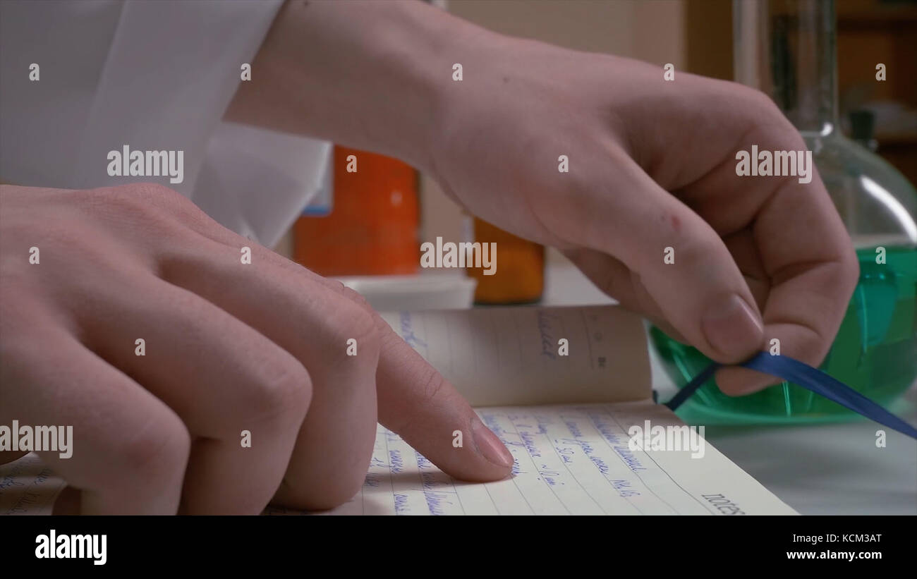 Hands open and looking something in a diary, notebook. hands of the ...