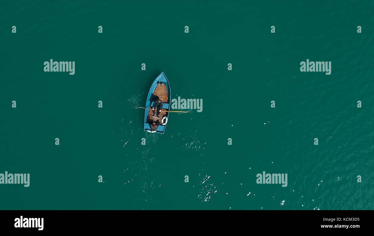 Aerial Boat on the lake. Aerial view on two men in a boat on a lake ...