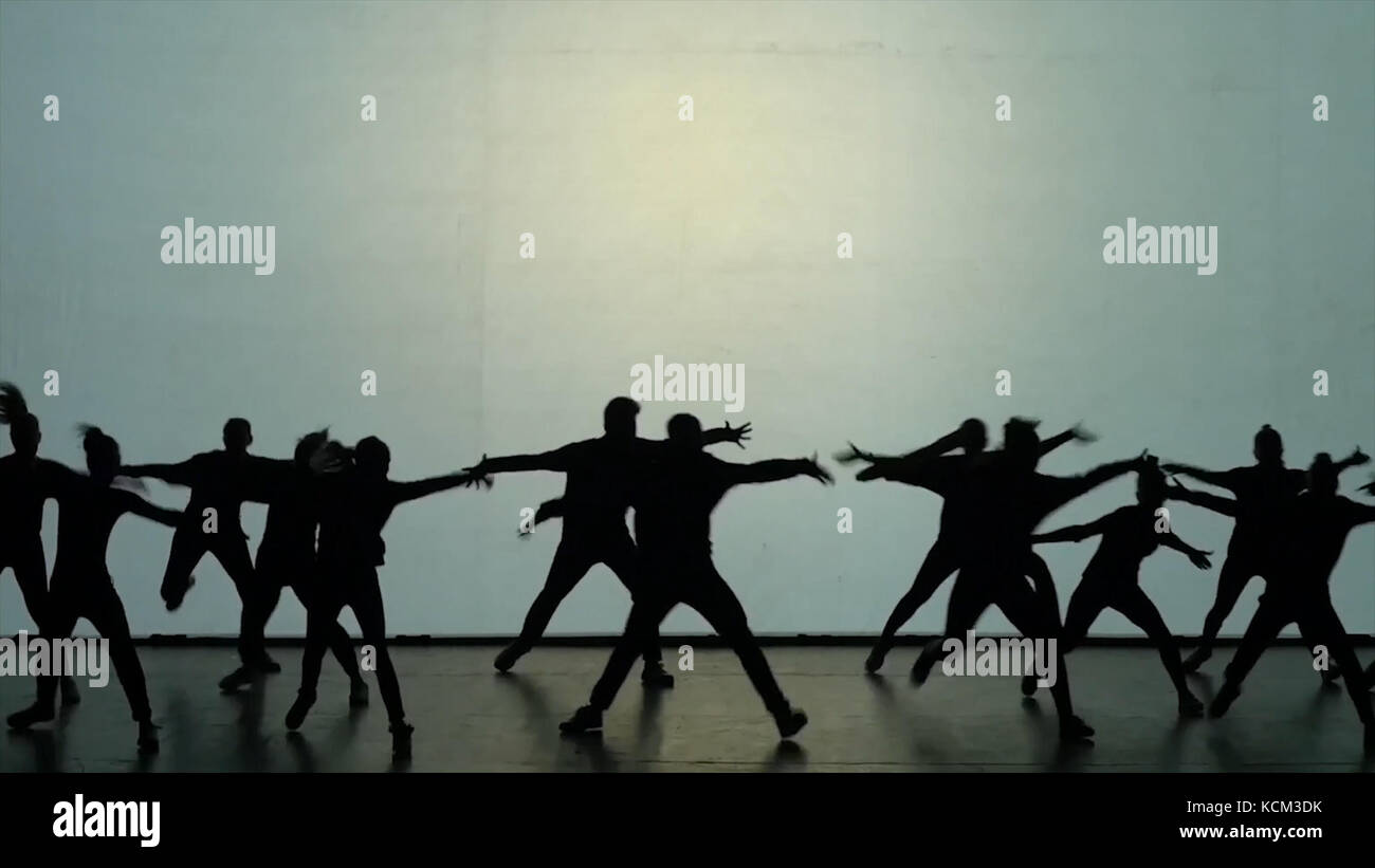 Dance of shadows. Dancers dancing on the stage. Dancers silhouettes ...