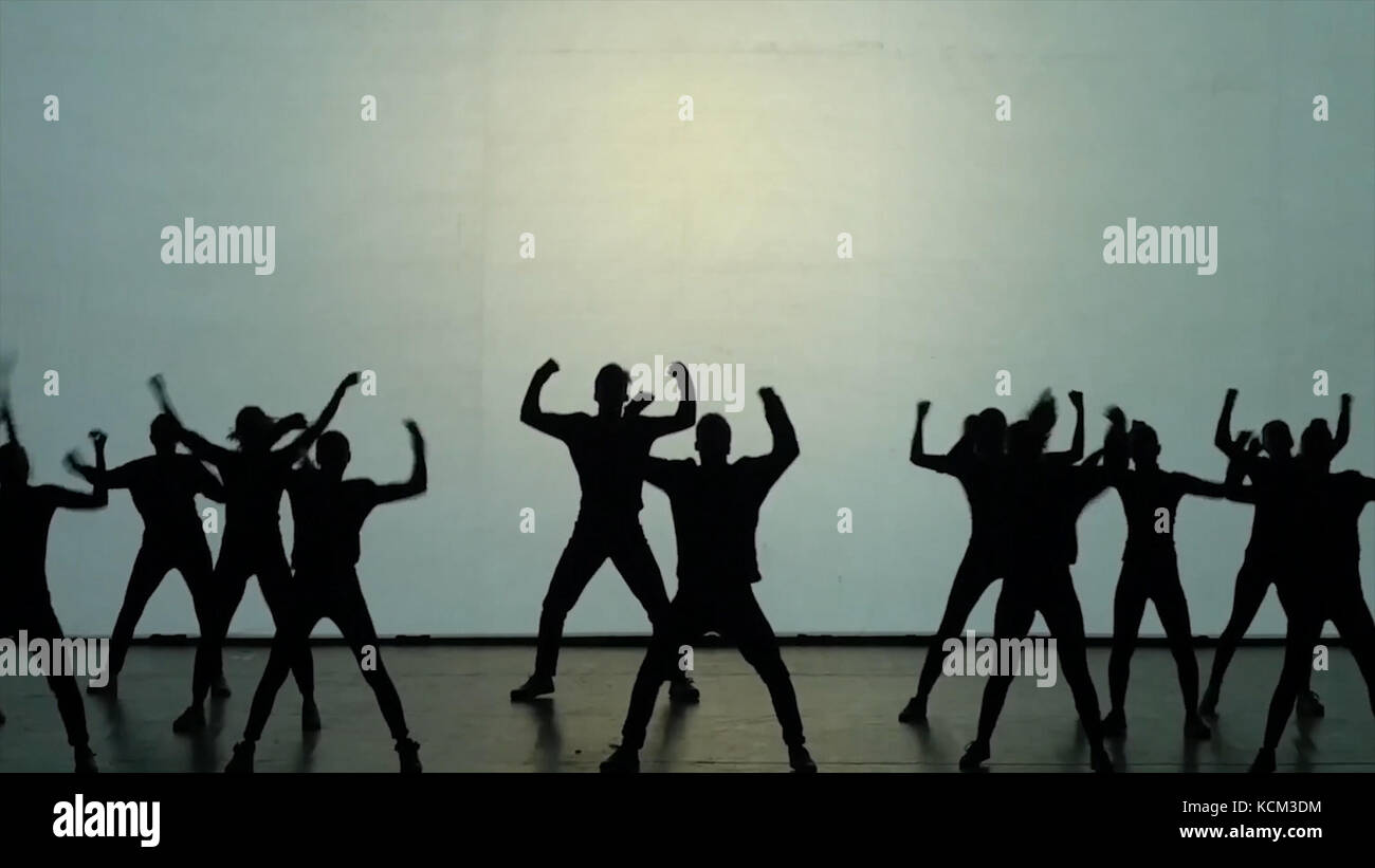 Dance of shadows. Dancers dancing on the stage. Dancers silhouettes ...