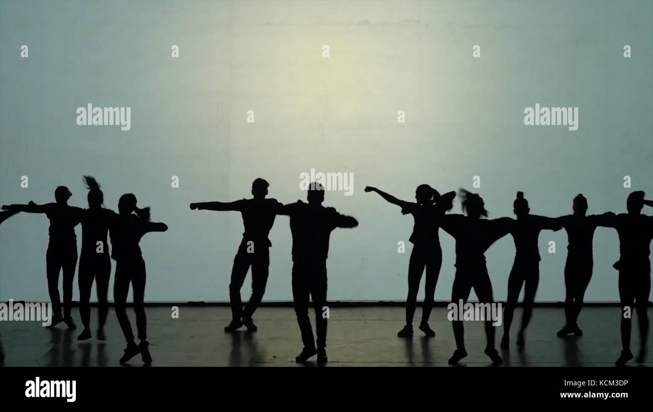 Dance of shadows. Dancers dancing on the stage. Dancers silhouettes ...