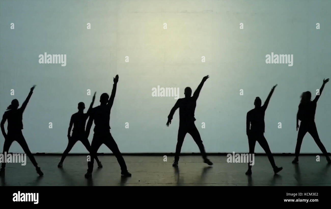 Dance of shadows. Dancers dancing on the stage. Dancers silhouettes ...