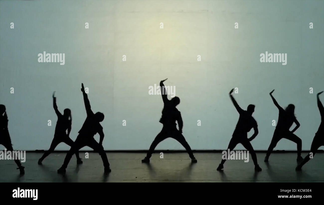 Dance of shadows. Dancers dancing on the stage. Dancers silhouettes ...