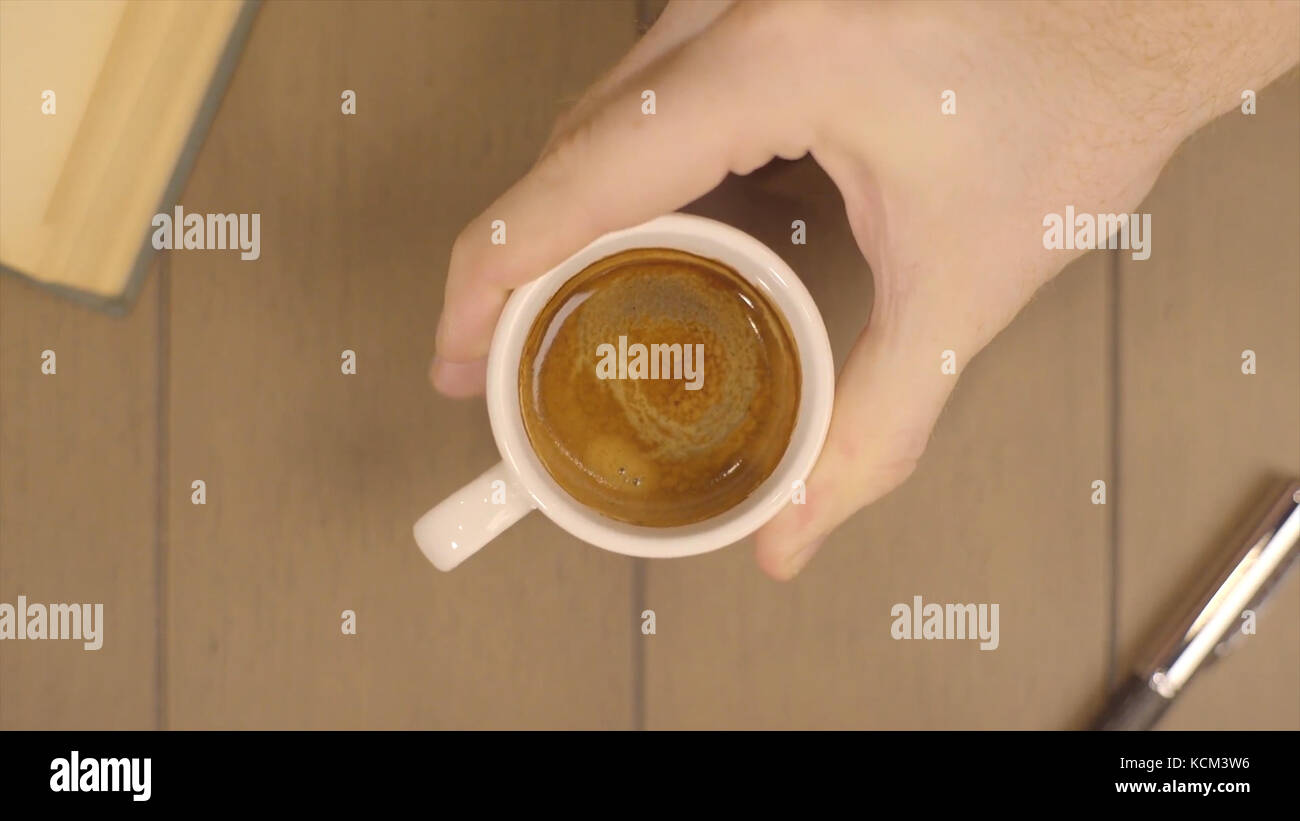 Human Hand Holding Coffee Cup Morning Drinks. Male moves a Cup of ...