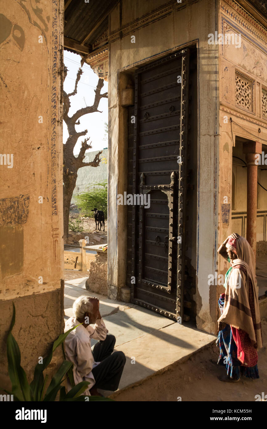 Woman looking through door hi-res stock photography and images - Alamy