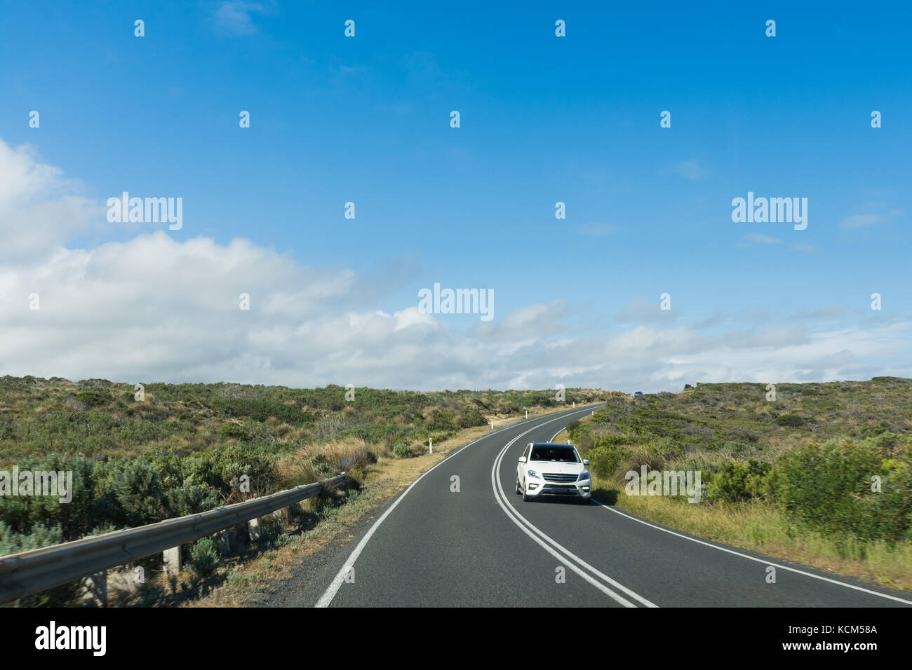 car diving down curved coastal road Stock Photo - Alamy
