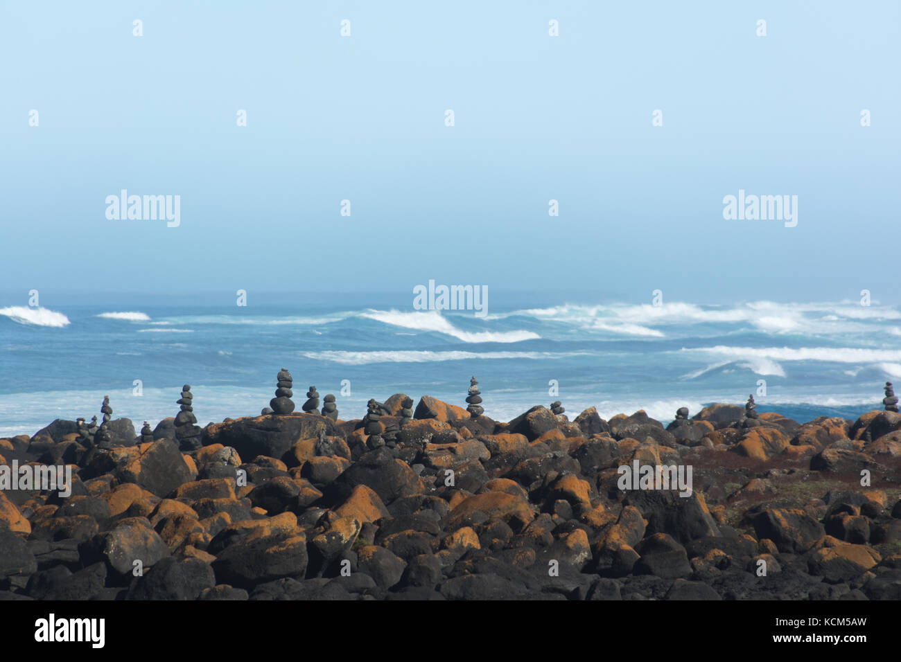 stacks of rocks on beach with waves Stock Photo - Alamy