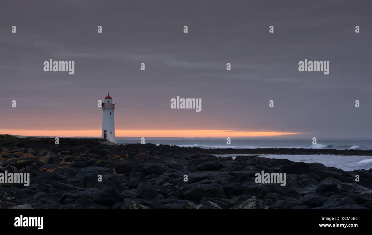 Port Fairy lighthouse at sunrise with rocks Stock Photo - Alamy