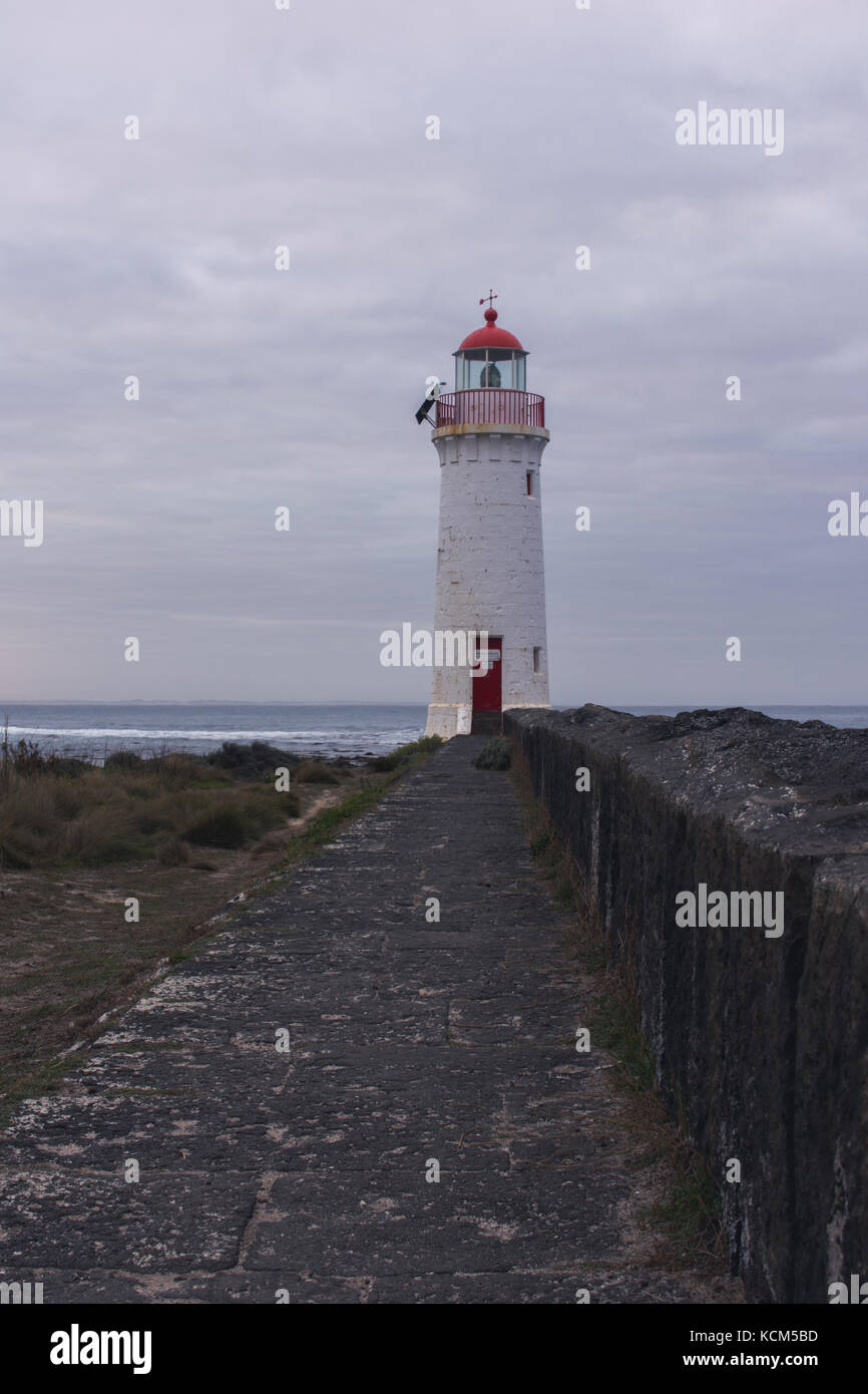 Port Fairy lighthouse at sunrise with rocks Stock Photo - Alamy