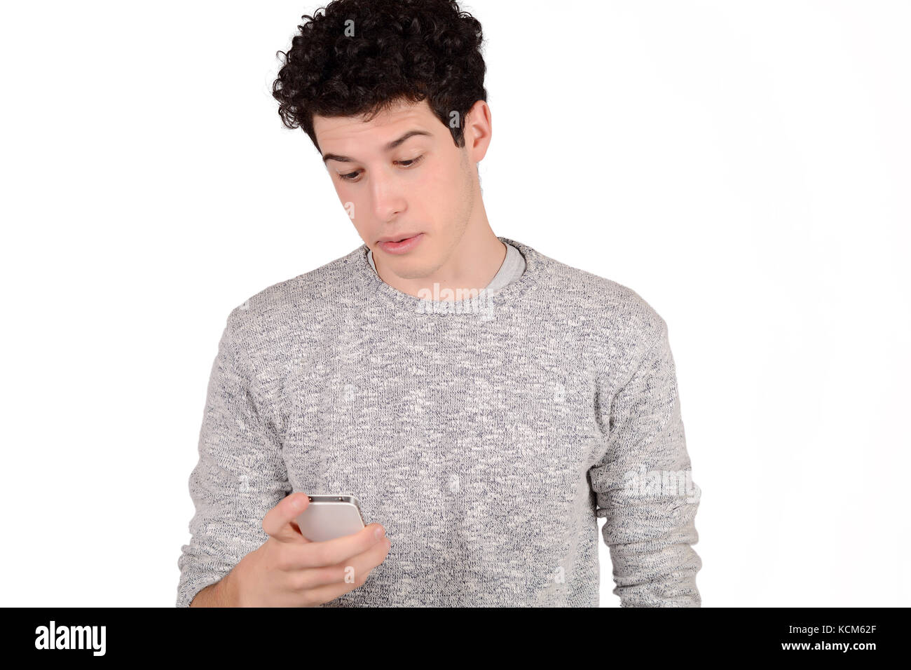 Portrait of a man typing on his smartphone. Isolated white background ...