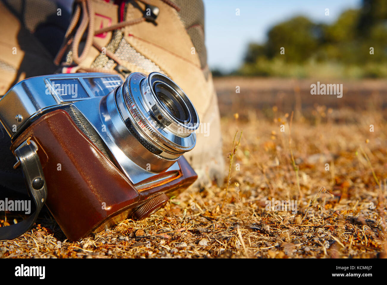 Vintage camera with hiking boots on the ground. Travel background Stock ...