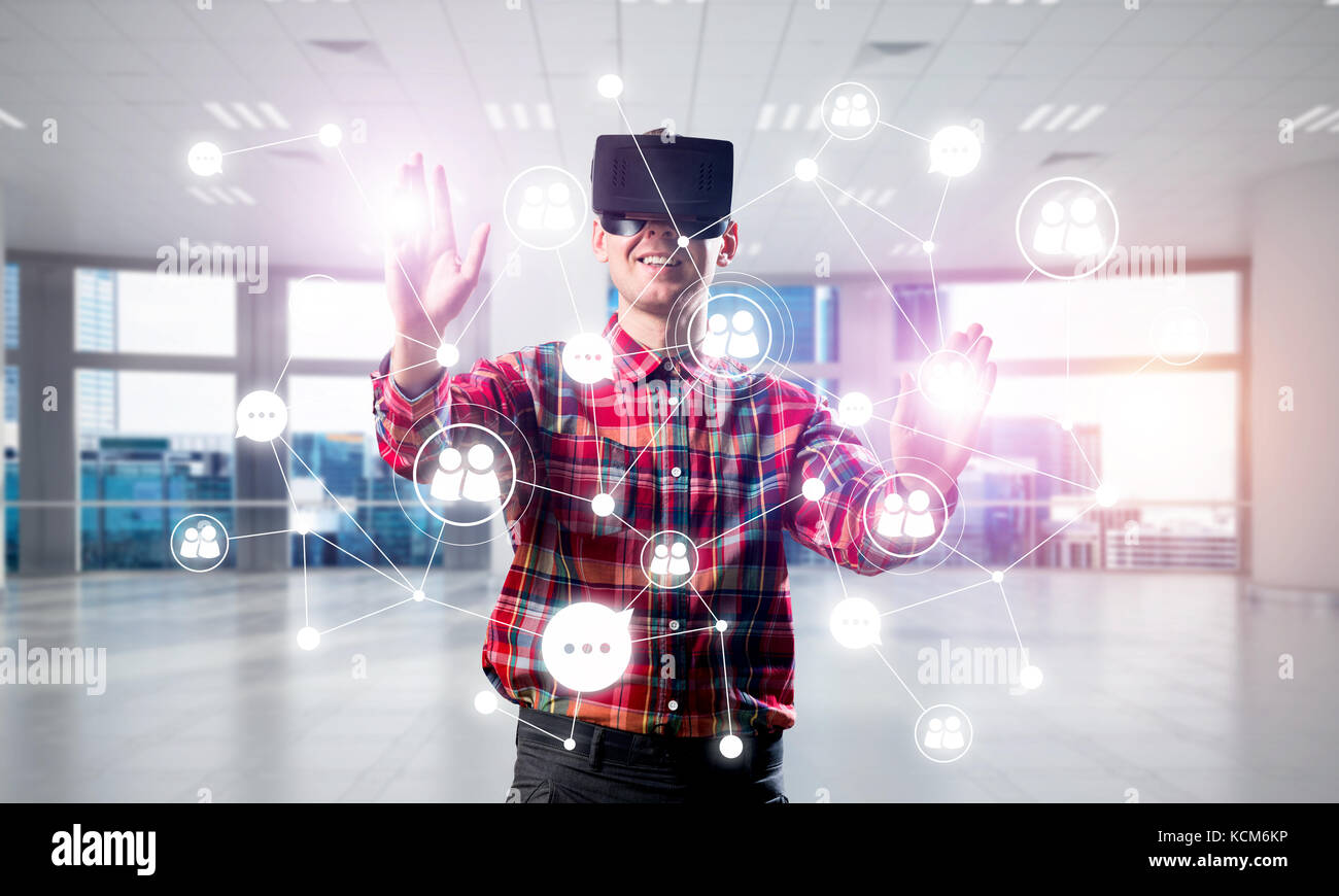 Guy wearing checked shirt and virtual mask reaching hand to touch ...