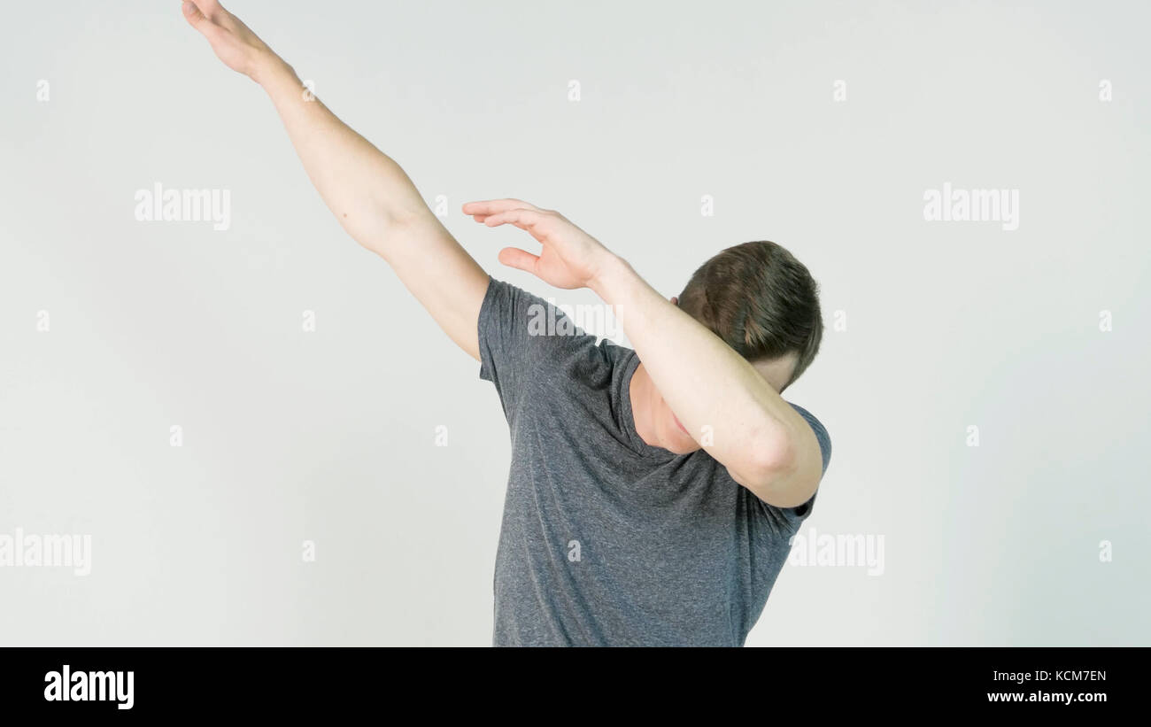 Young man makes a dab or flex it's dance move on white background Stock ...