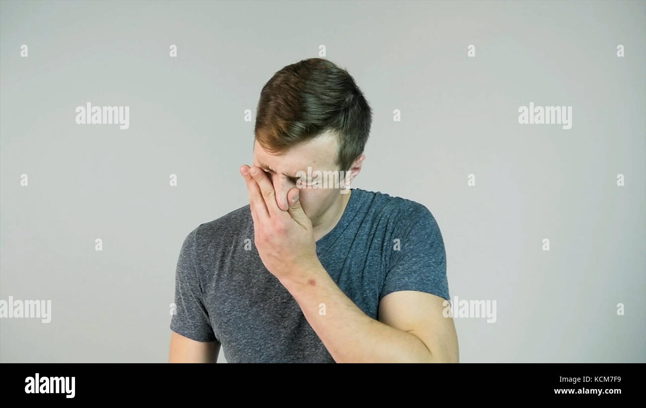 Young man sneezing on a white background, slow motion Stock Photo - Alamy