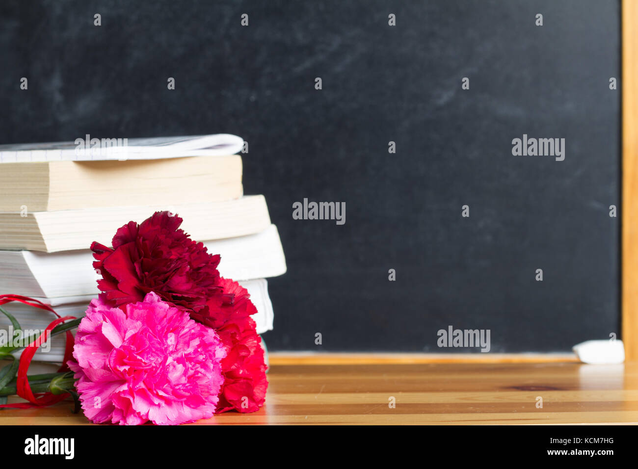 Flowers and blackboard in classroom teacher day background concept ...