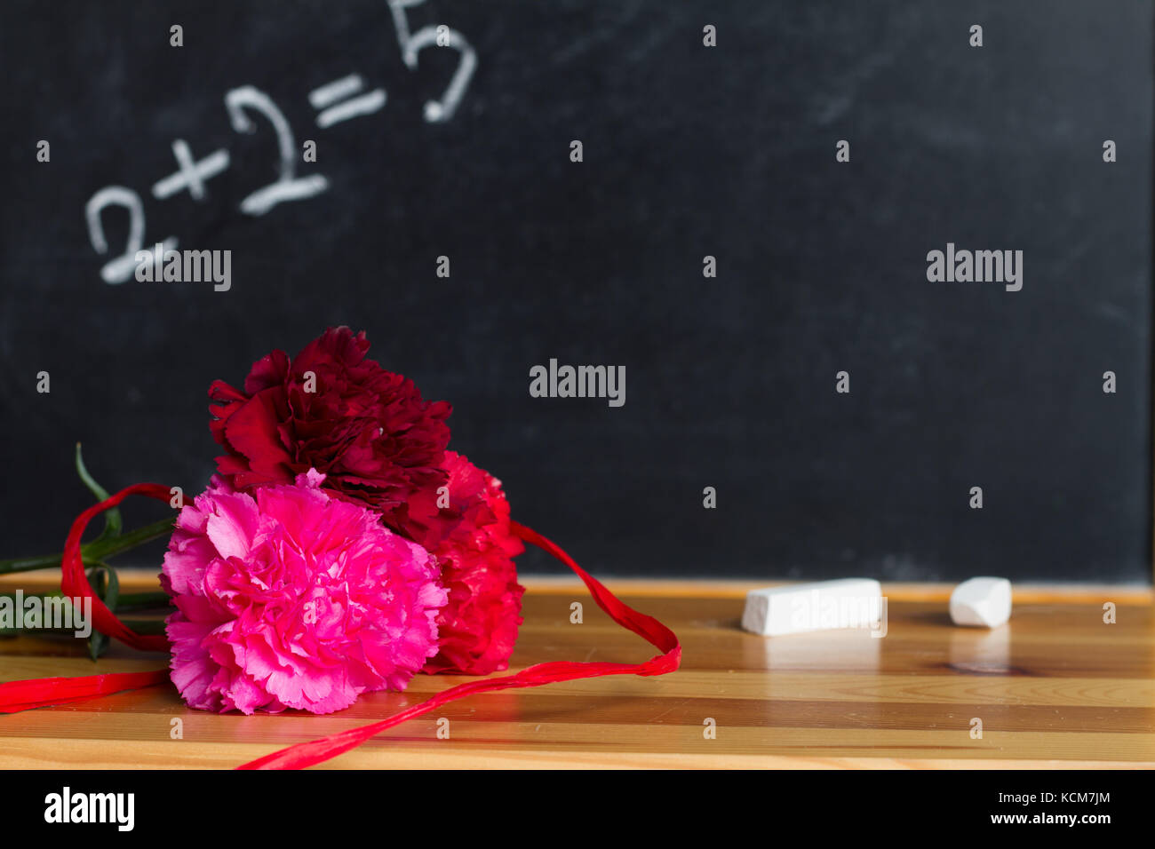 Flowers and blackboard in classroom teacher day background concept ...