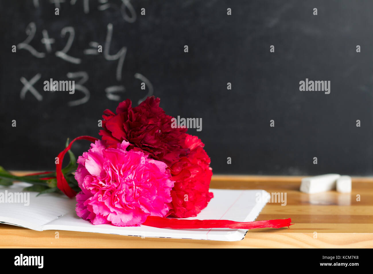 Flowers and blackboard in classroom teacher day background concept ...