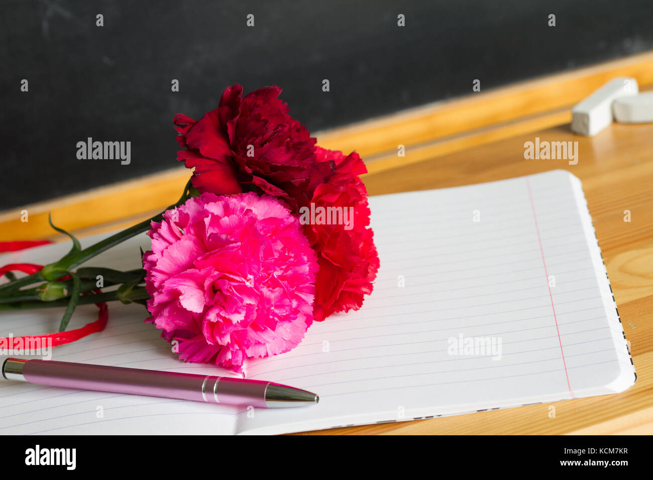 Flowers and blackboard in classroom teacher day background concept ...