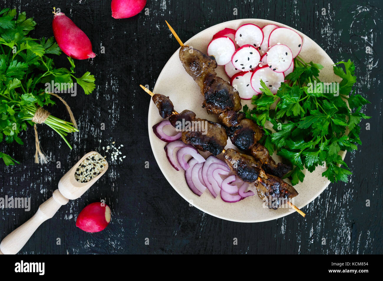 Rabbit liver roasted on skewers and radish salad. A dietary dish Stock ...