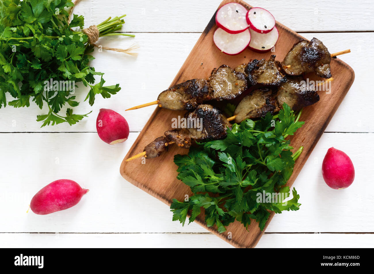 Rabbit liver roasted on skewers with herbs and radish. A dietary dish ...