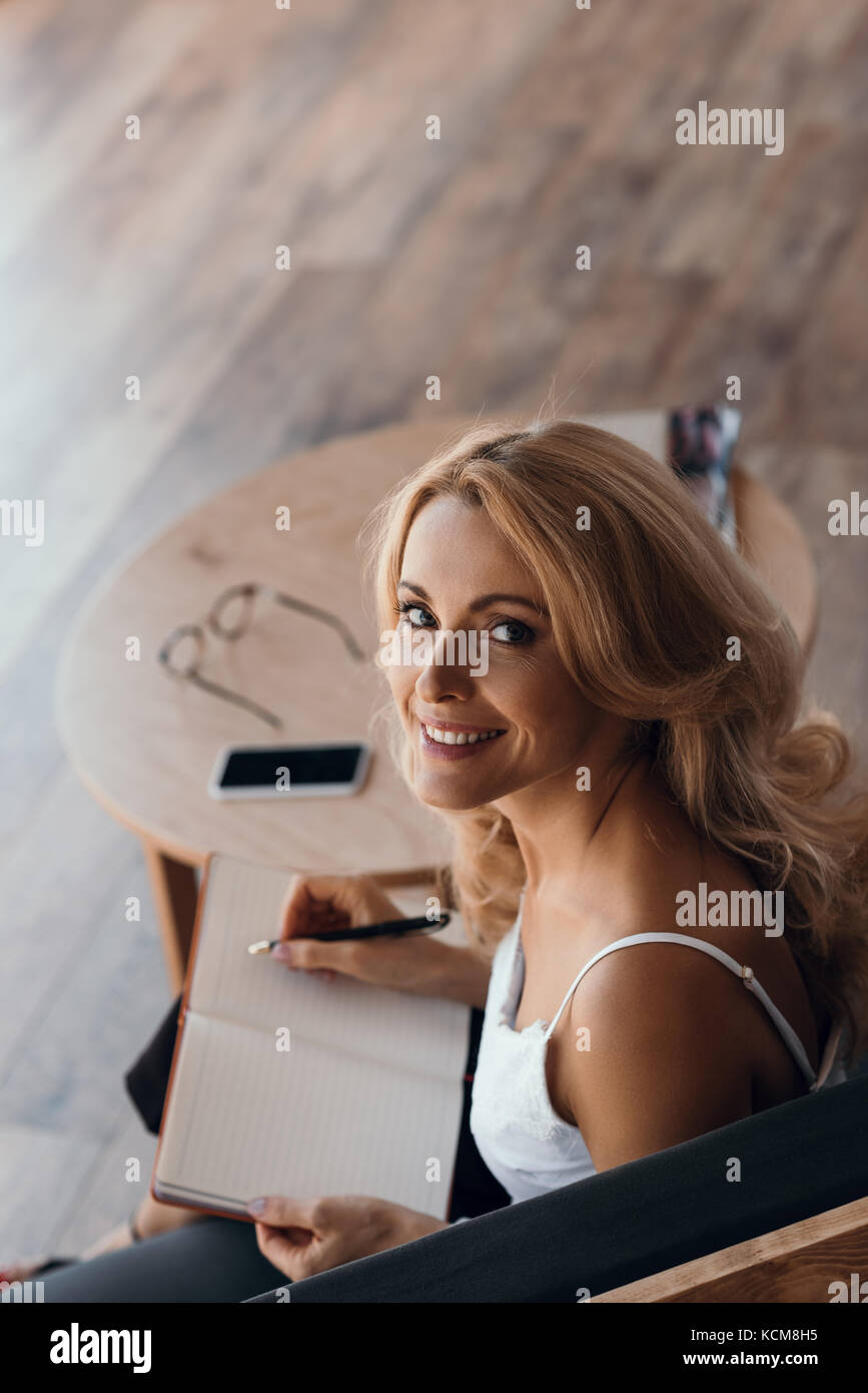 woman writing in notebook Stock Photo - Alamy