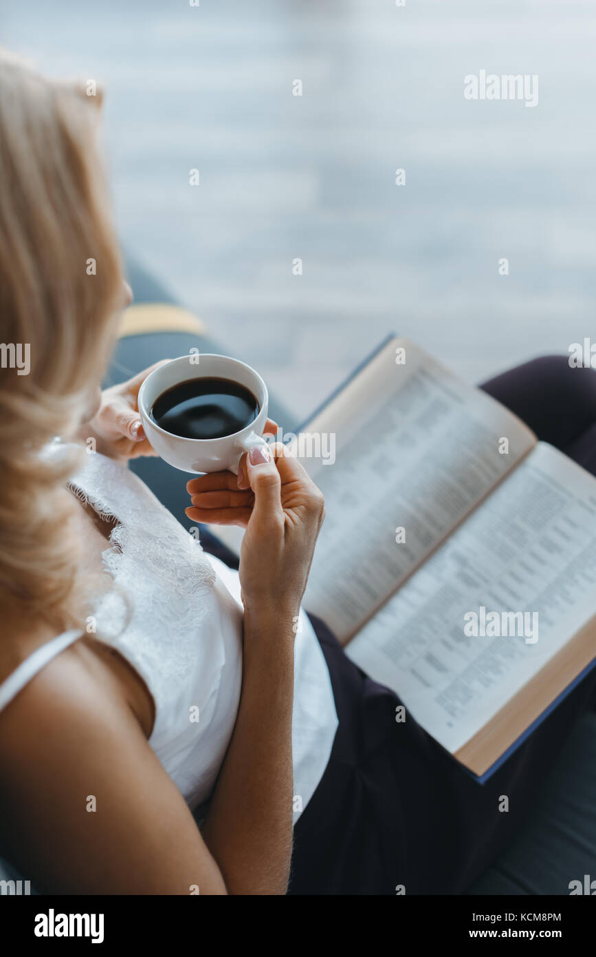 woman reading book and drinking coffee Stock Photo - Alamy