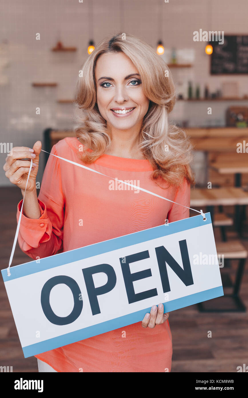 cafe owner with sign open Stock Photo - Alamy