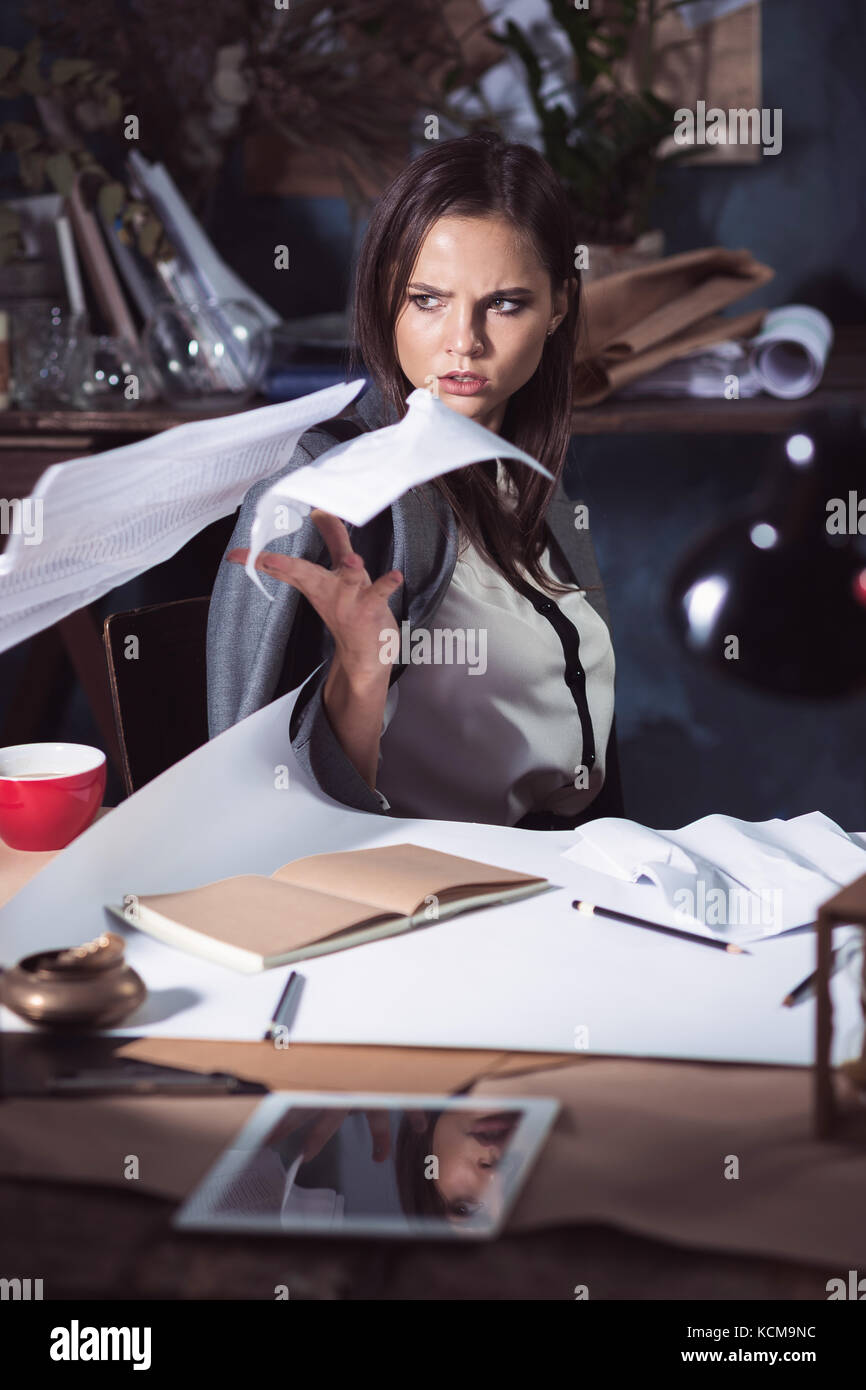 Young business woman throwing documents at camera Stock Photo - Alamy