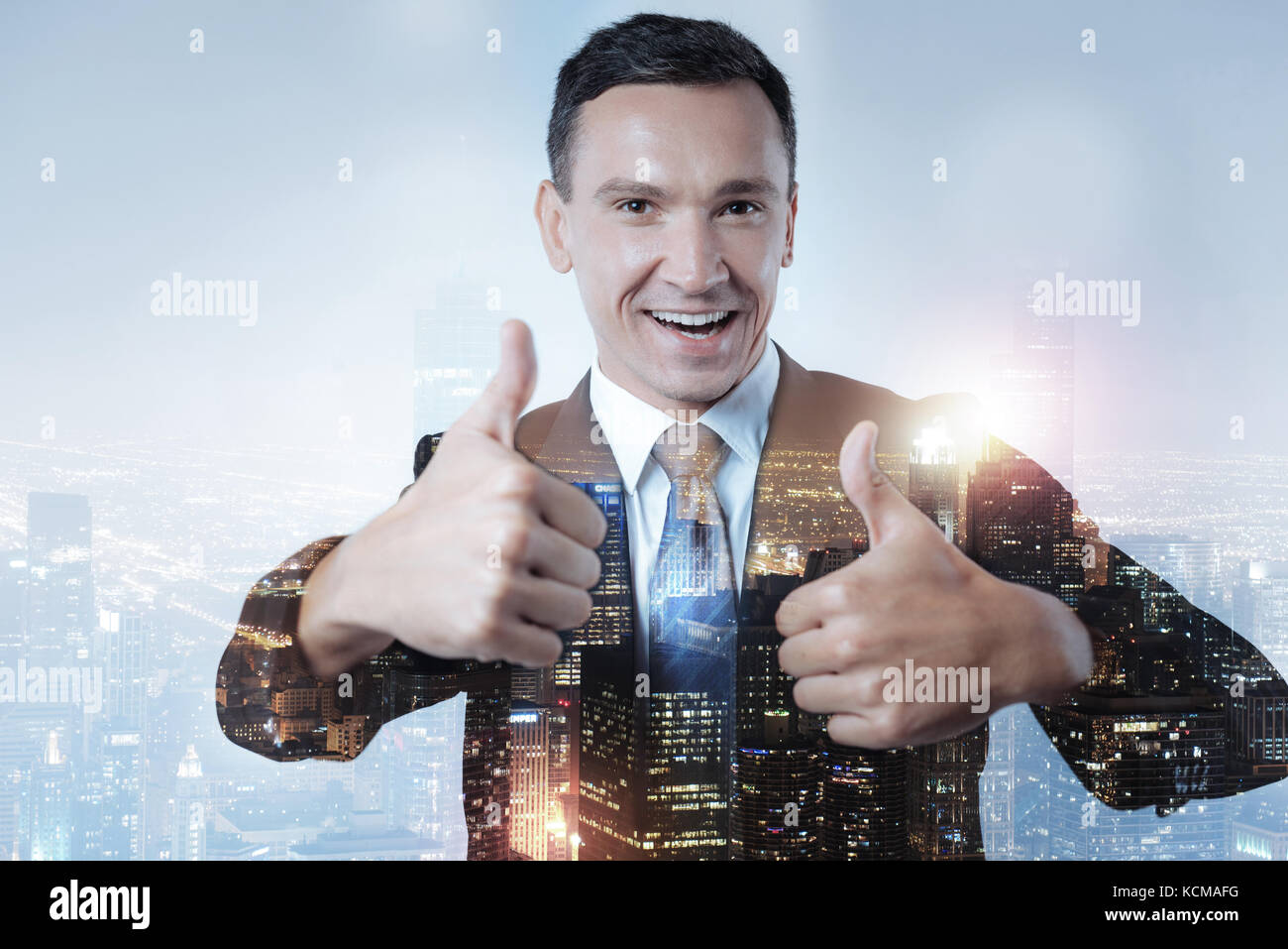 Optimistic manager raising two thumbs up Stock Photo - Alamy