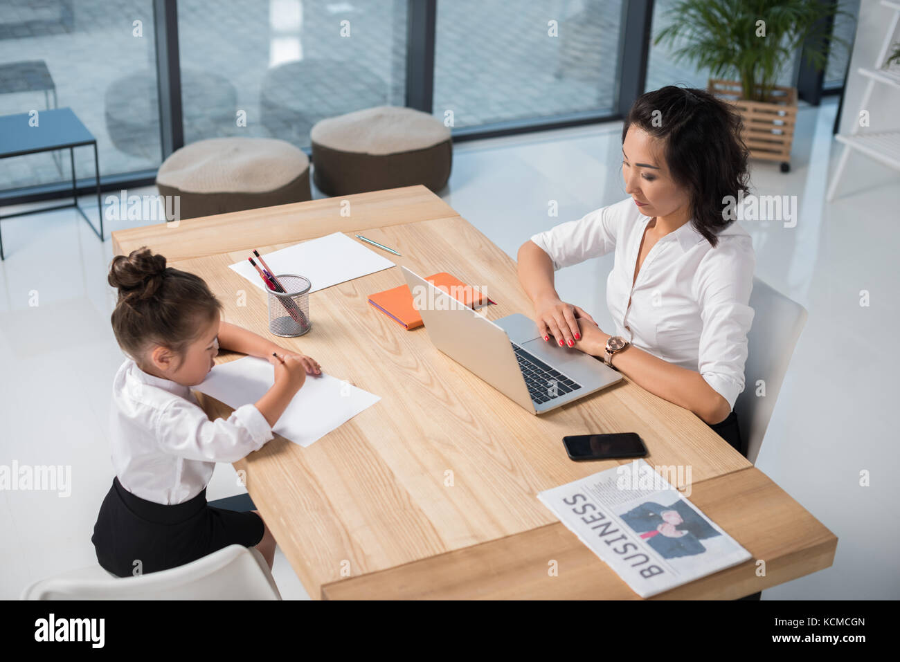 asian businesswoman with daughter in office Stock Photo - Alamy