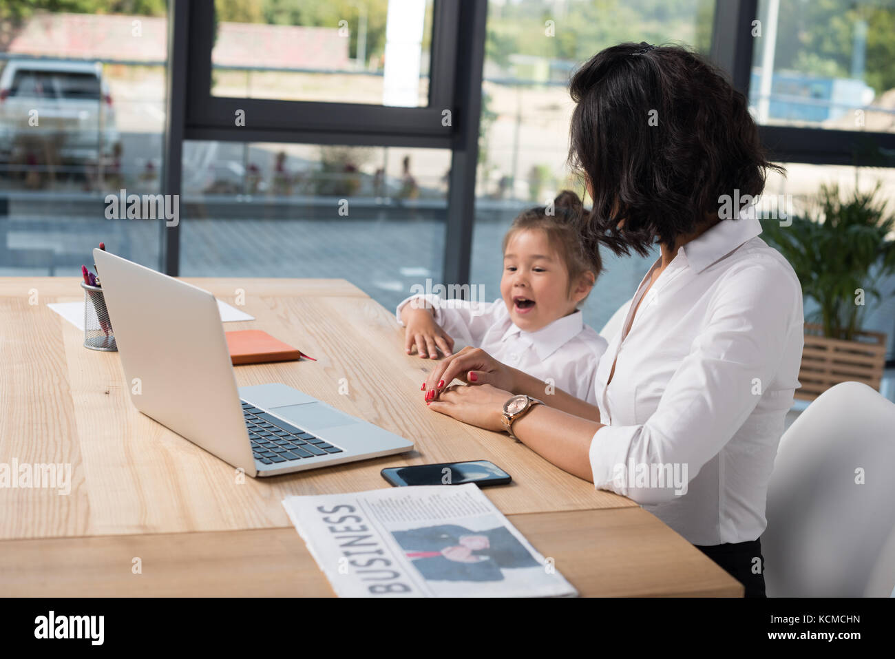 asian businesswoman with daughter in office Stock Photo - Alamy