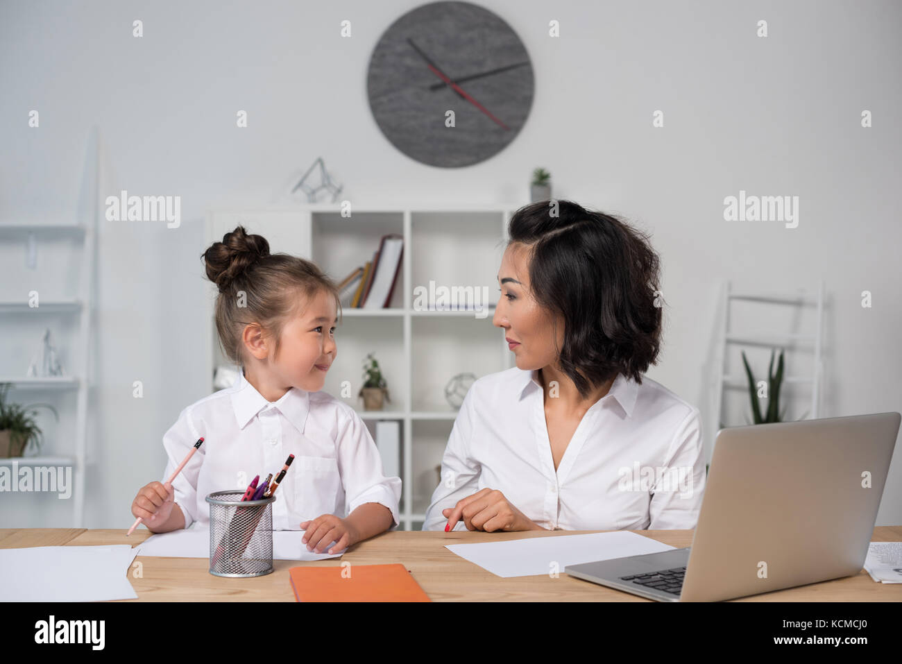 asian businesswoman with daughter in office Stock Photo - Alamy