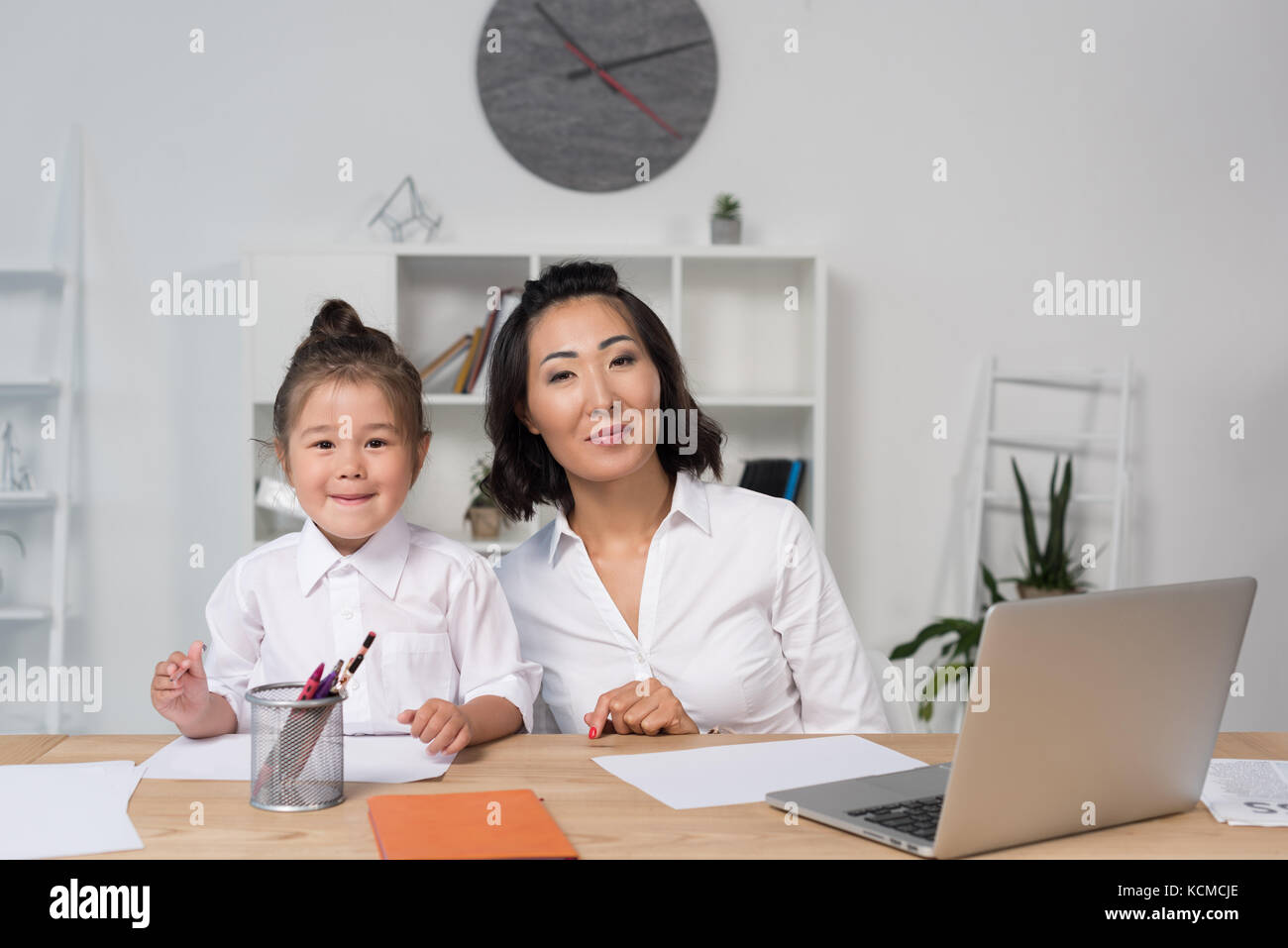 asian businesswoman with daughter in office Stock Photo - Alamy