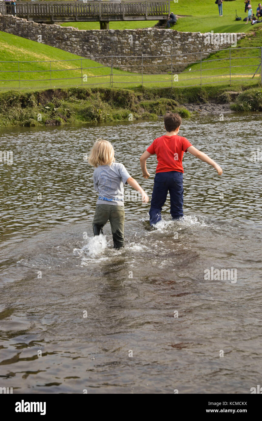 Children splashing through a river Stock Photo - Alamy