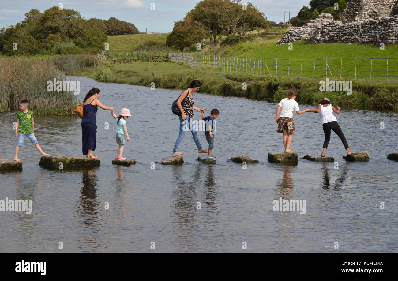 Families crossing a river on stepping stones Stock Photo - Alamy