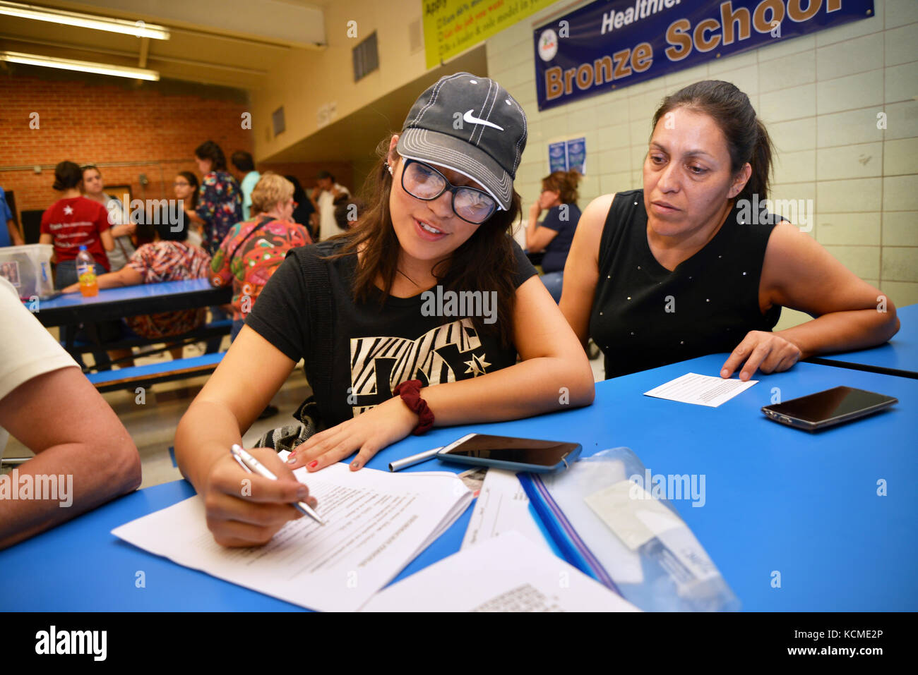 Volunteers from Keep Tucson Together and attorney Margo Cowan provide ...