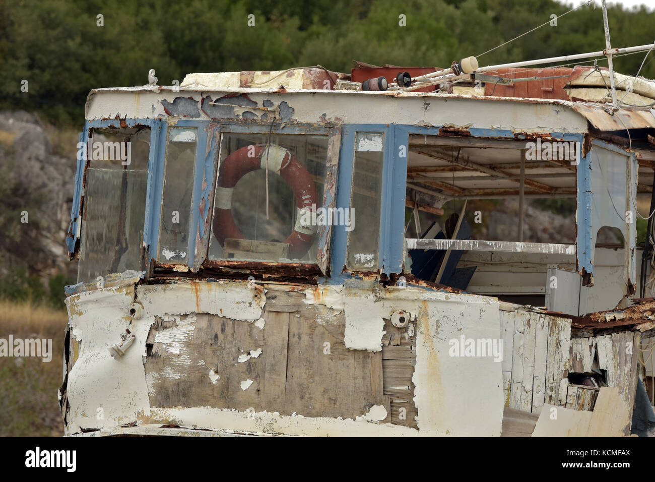 the hulk of an old boat or ship left to rot in a harbour close to ...