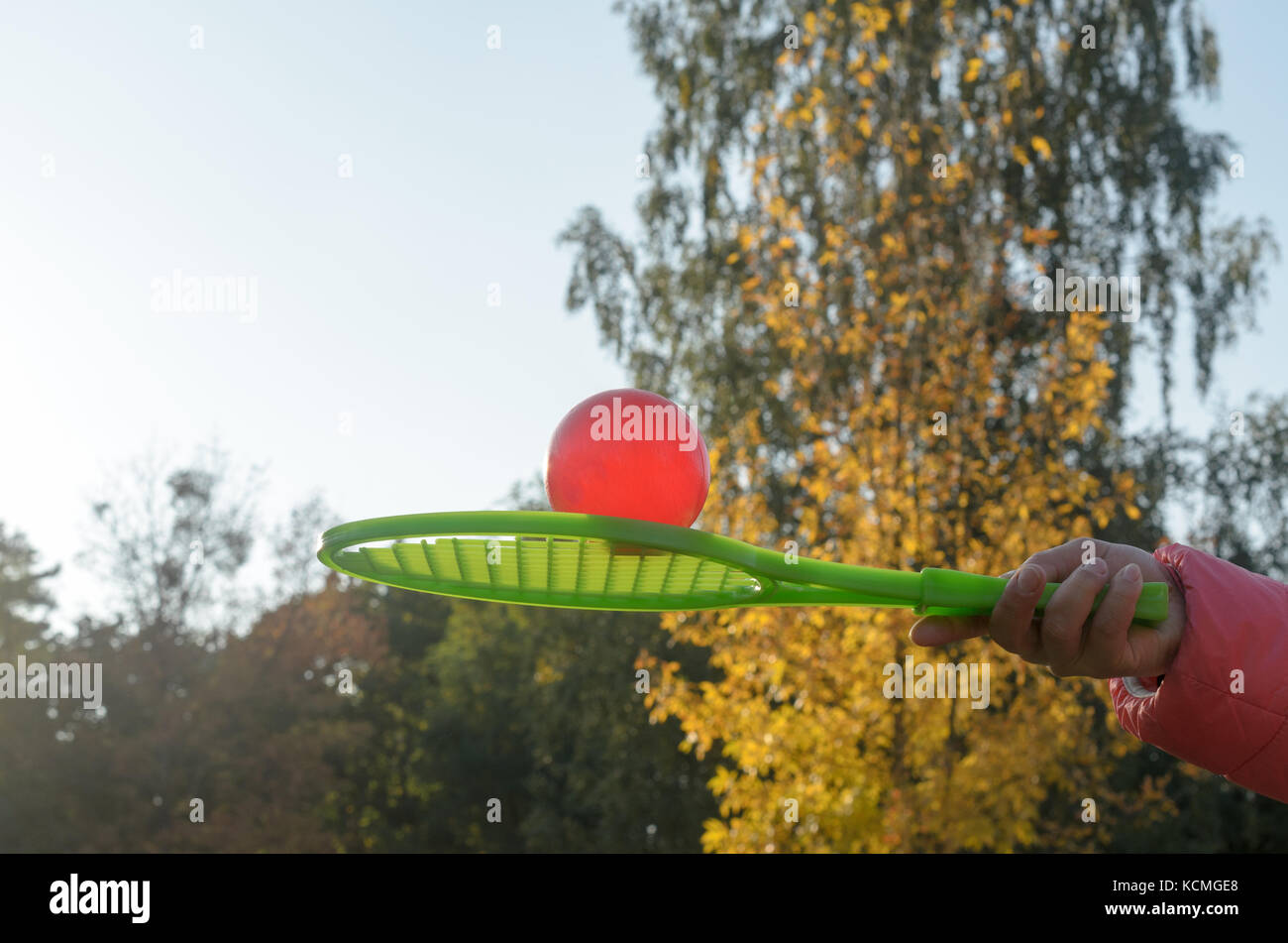 A tennis racket in his hand catches the ball in motion Stock Photo - Alamy