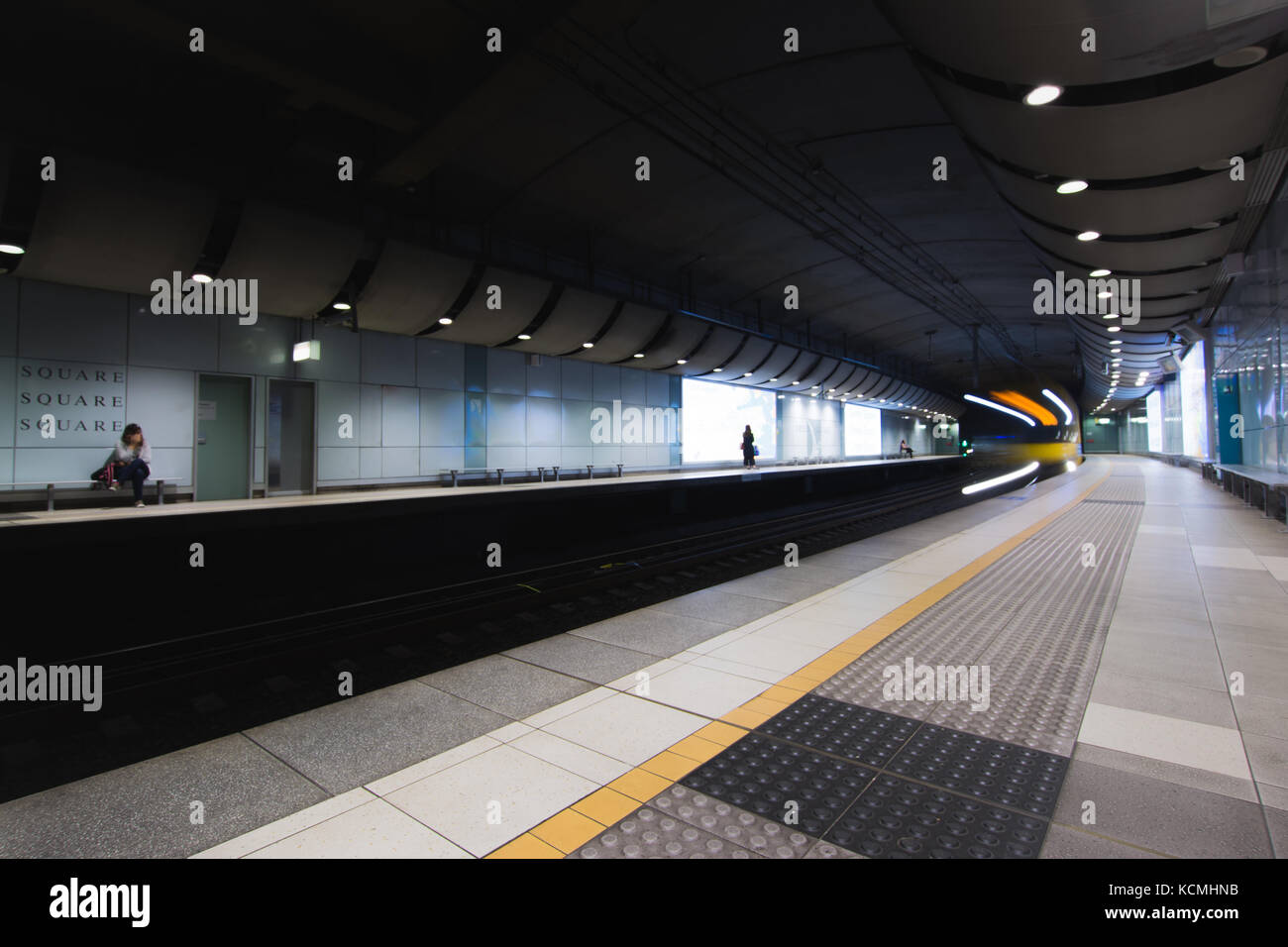 passenger train speeding through an underground station of a urban city ...