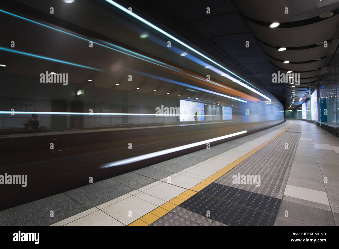 passenger train speeding through an underground station of a urban city ...