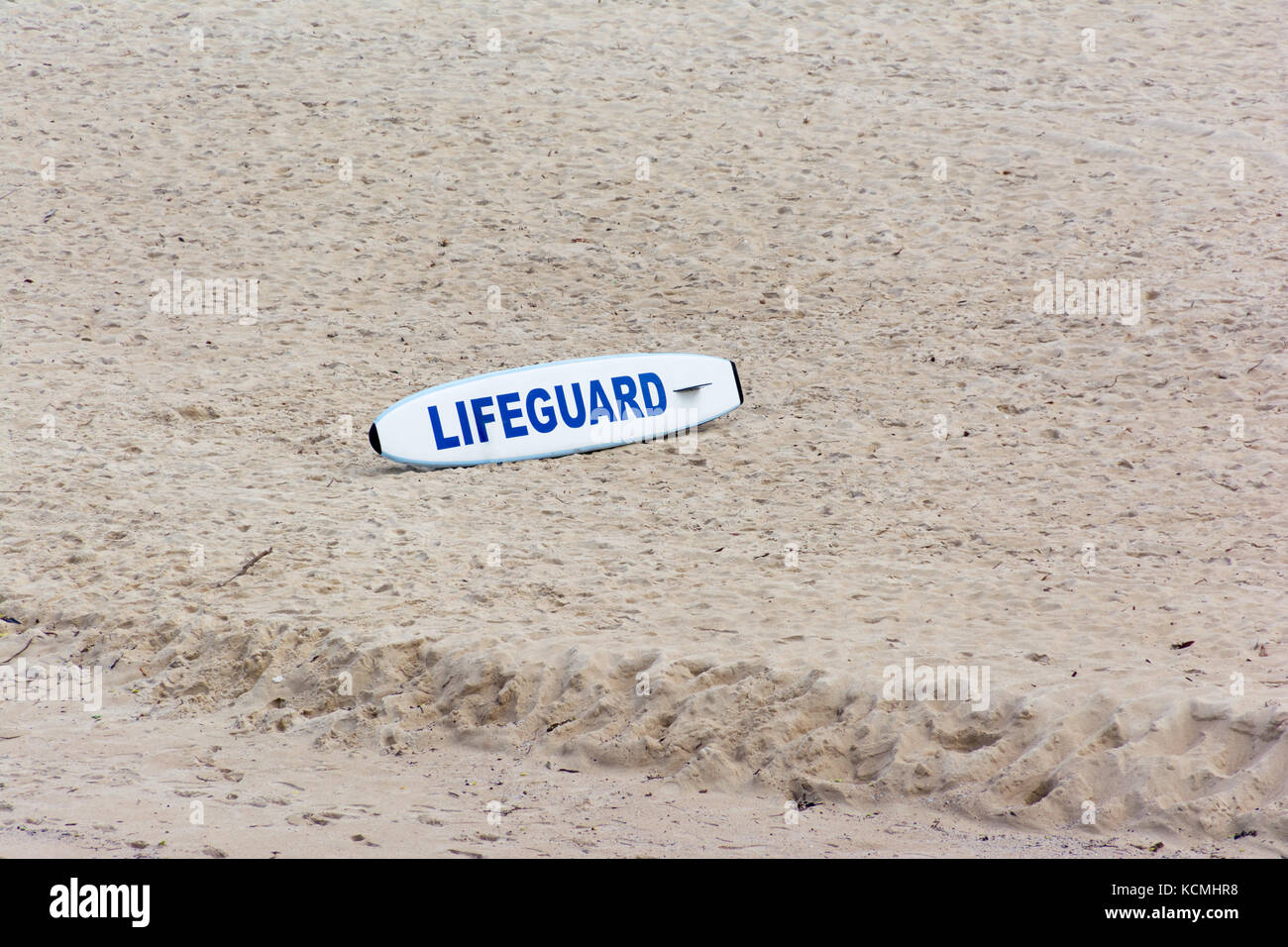 White surfboard with lifeguard text sitting on sandy beach Stock Photo ...