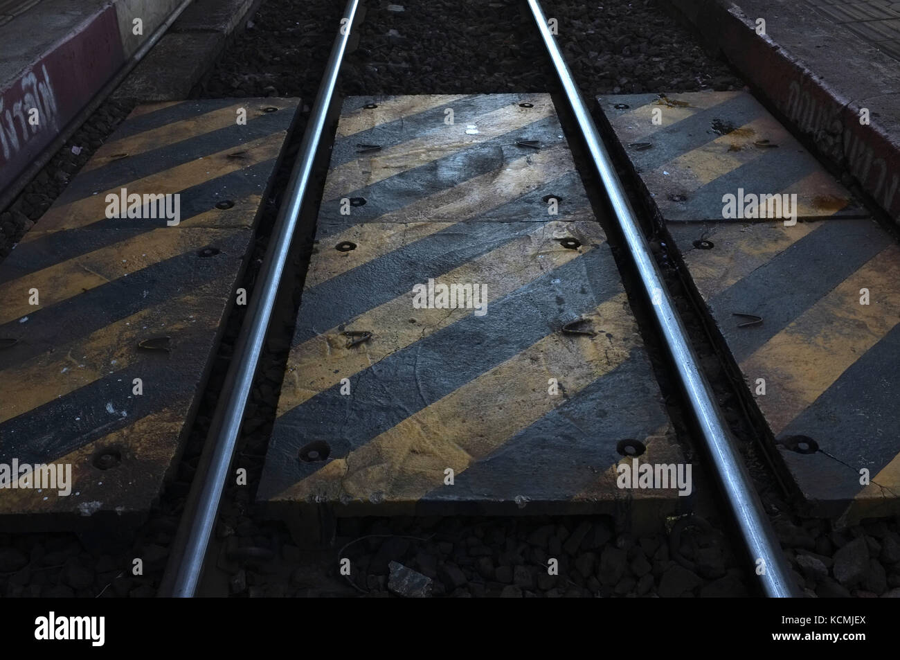 Yellow and white line sign on railway track warning while walk across ...